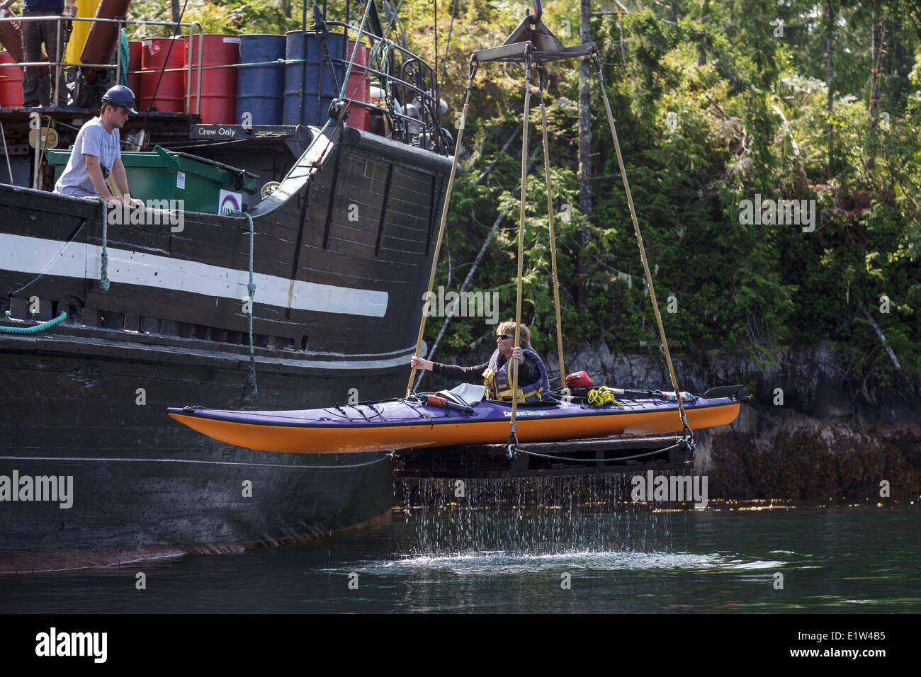 A kayaker is lifted onto the supply ship the Uchuck 111 at Flynn's Cove ...