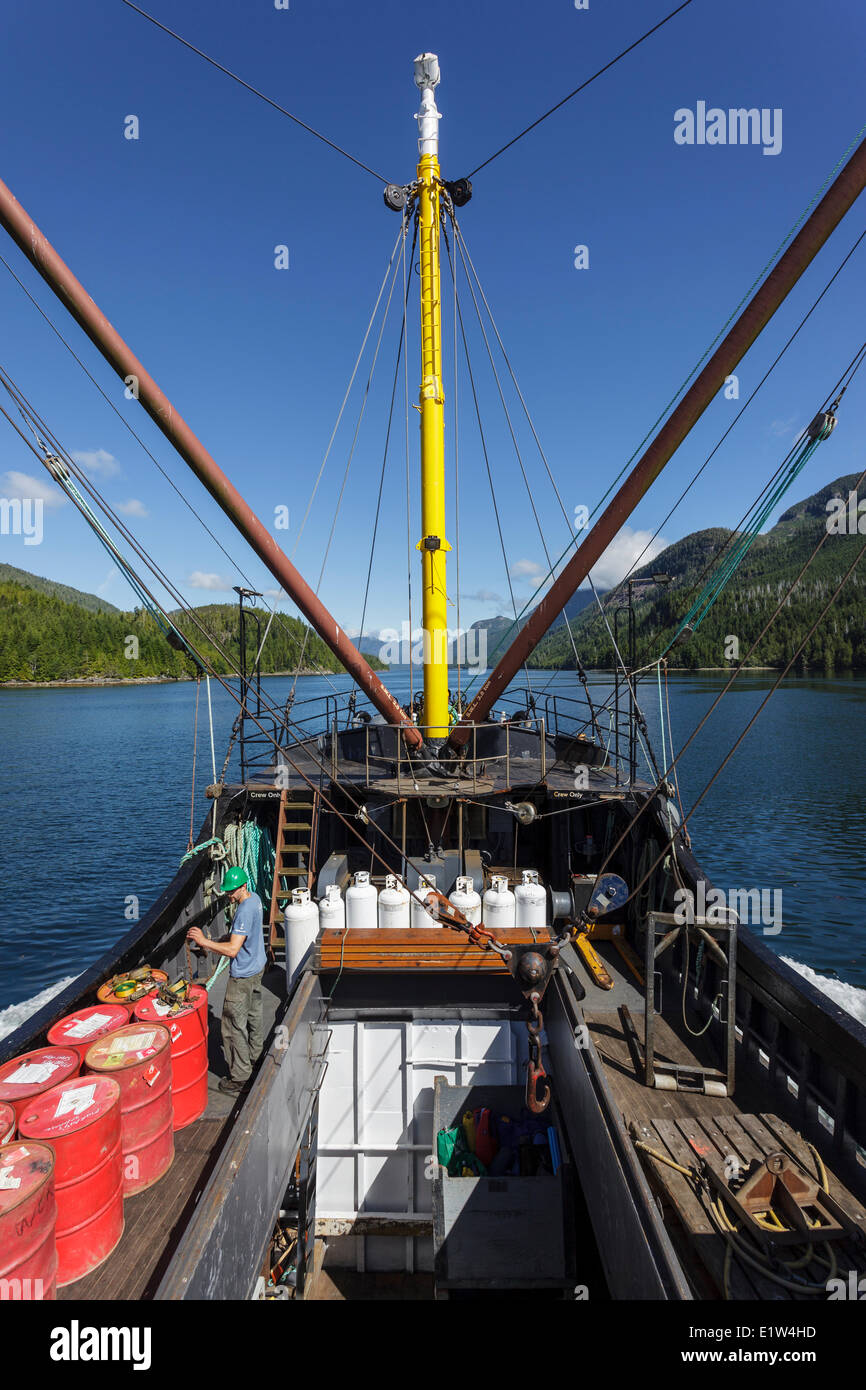 A crew member on the Uchuck 111 prepares barrels of fuel for delivery ...