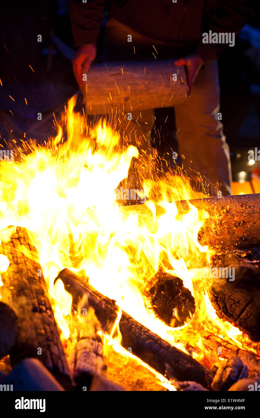Stoking the fire while on a camping/kayaking trip. White River, BC ...