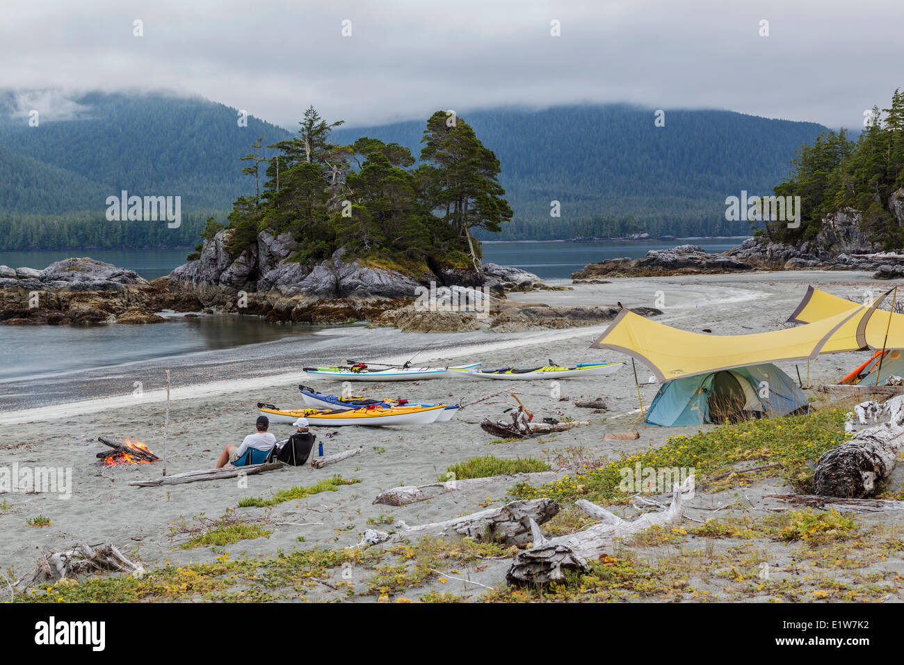 Two kaykers relax by their campfire on Benson Point after a days ...