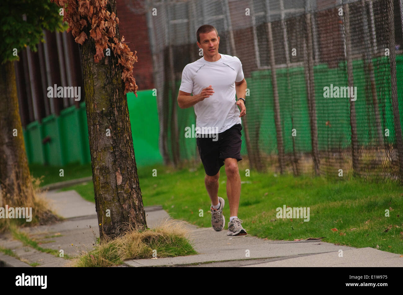 Man running on sidewalk in downtown Vancouver, British Columbia, Canada ...