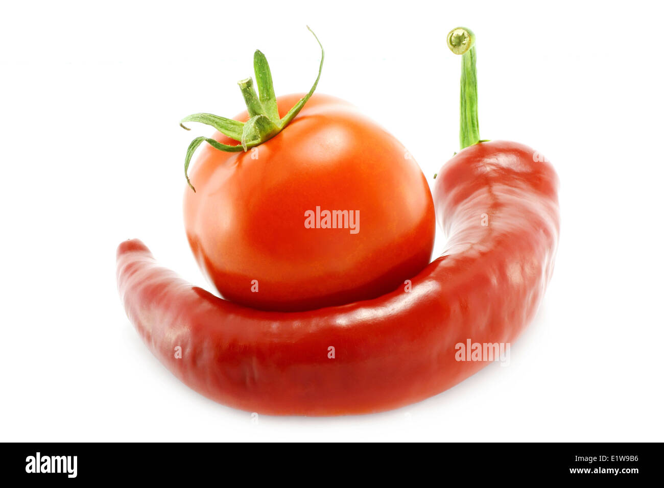 Red hot chili pepper and tomato on a white background Stock Photo - Alamy