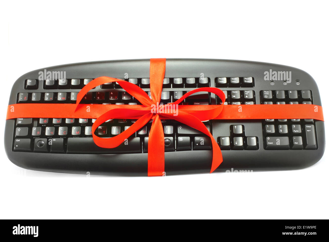 Computer keyboard with red bow on a white background Stock Photo - Alamy