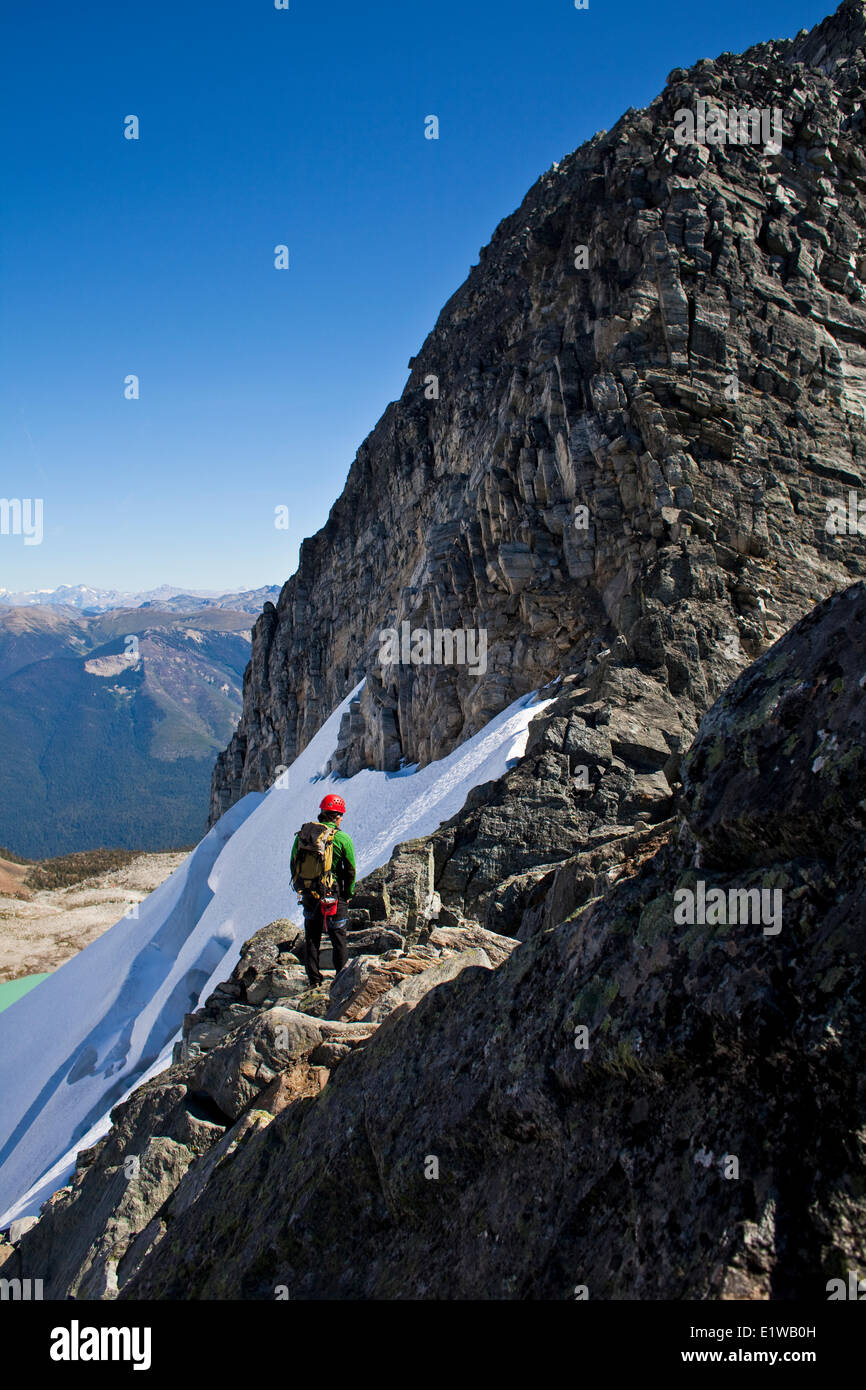 A young man alpine climbing the west ridge of Mt Tupper, Roger's Pass ...