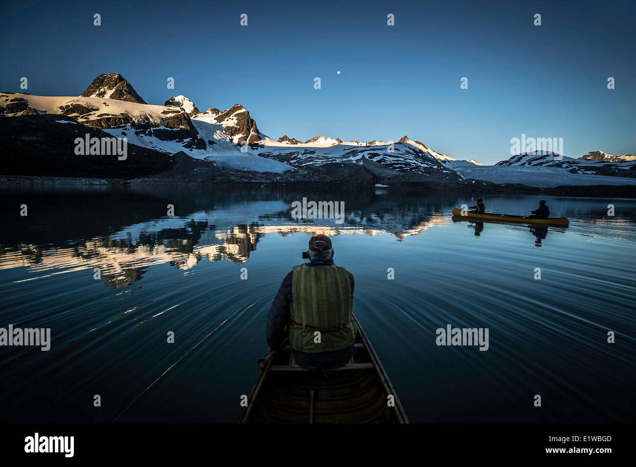 Canoeing on Ape Lake near glacier, Chilcotin, Coast Mountains, British ...