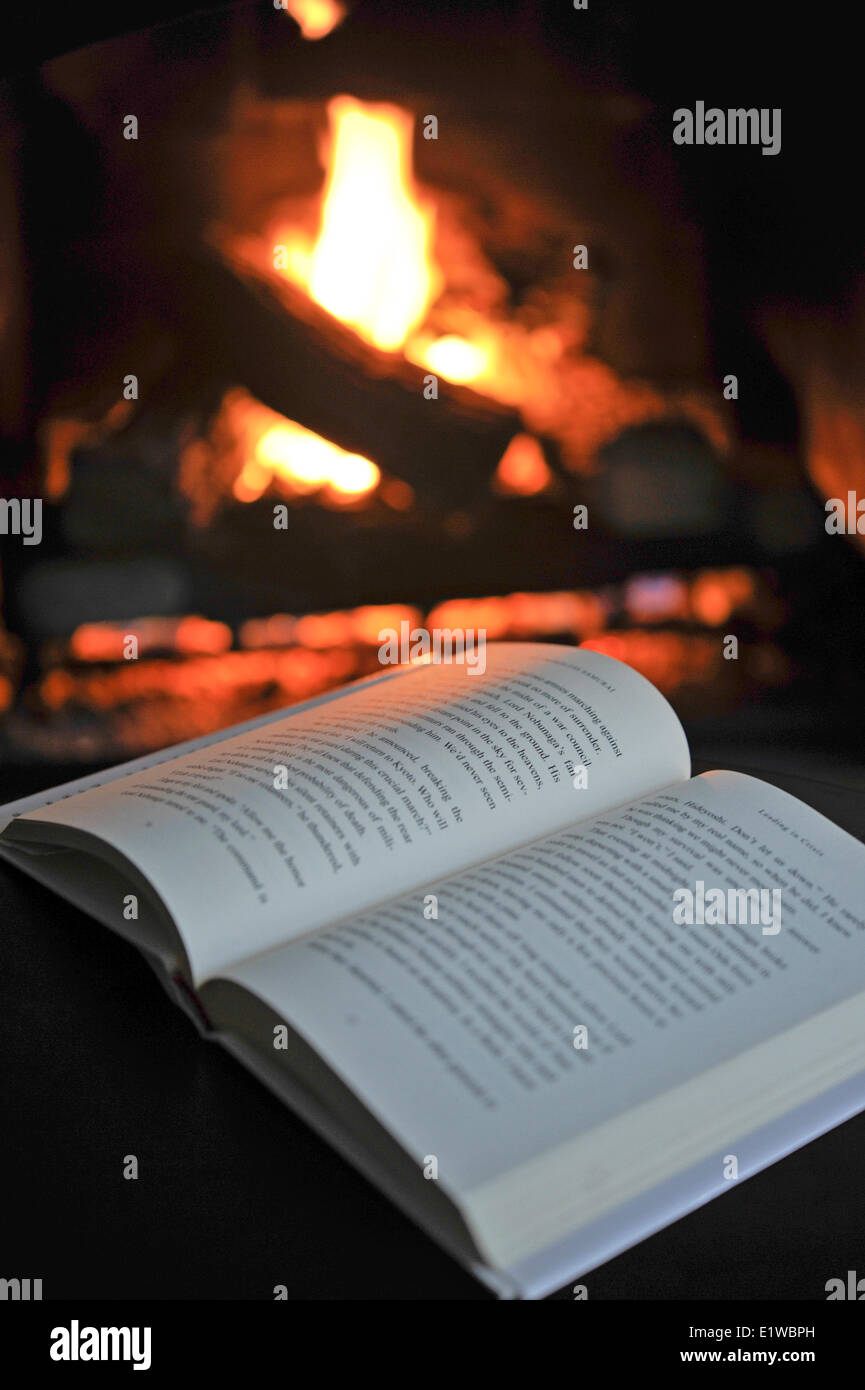 Open book by a fireplace Stock Photo - Alamy
