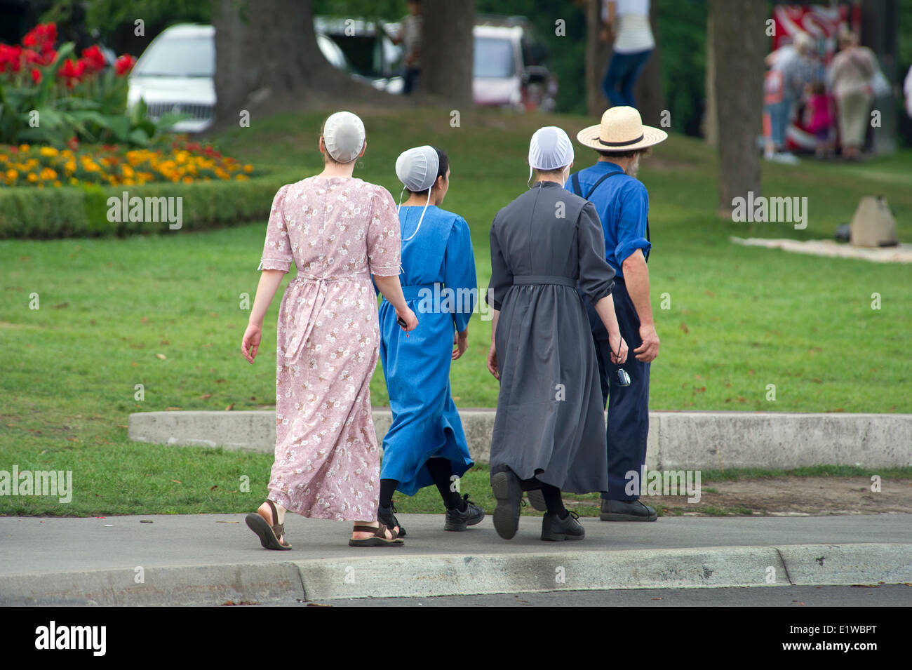 Mennonite girls with father walking on street in niagara falls hi-res ...