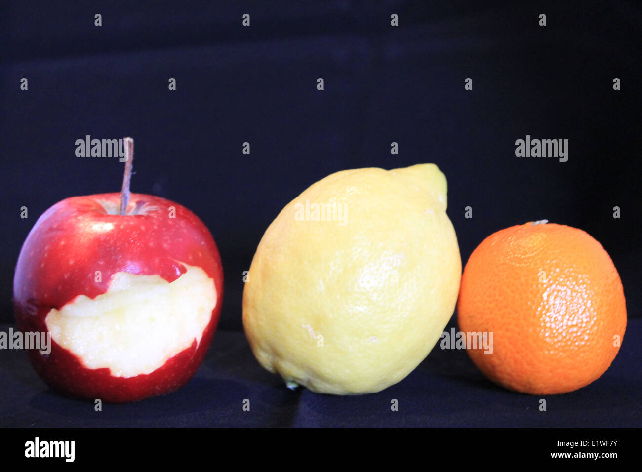 Apple Lemon and Orange Fruits in a row Stock Photo - Alamy