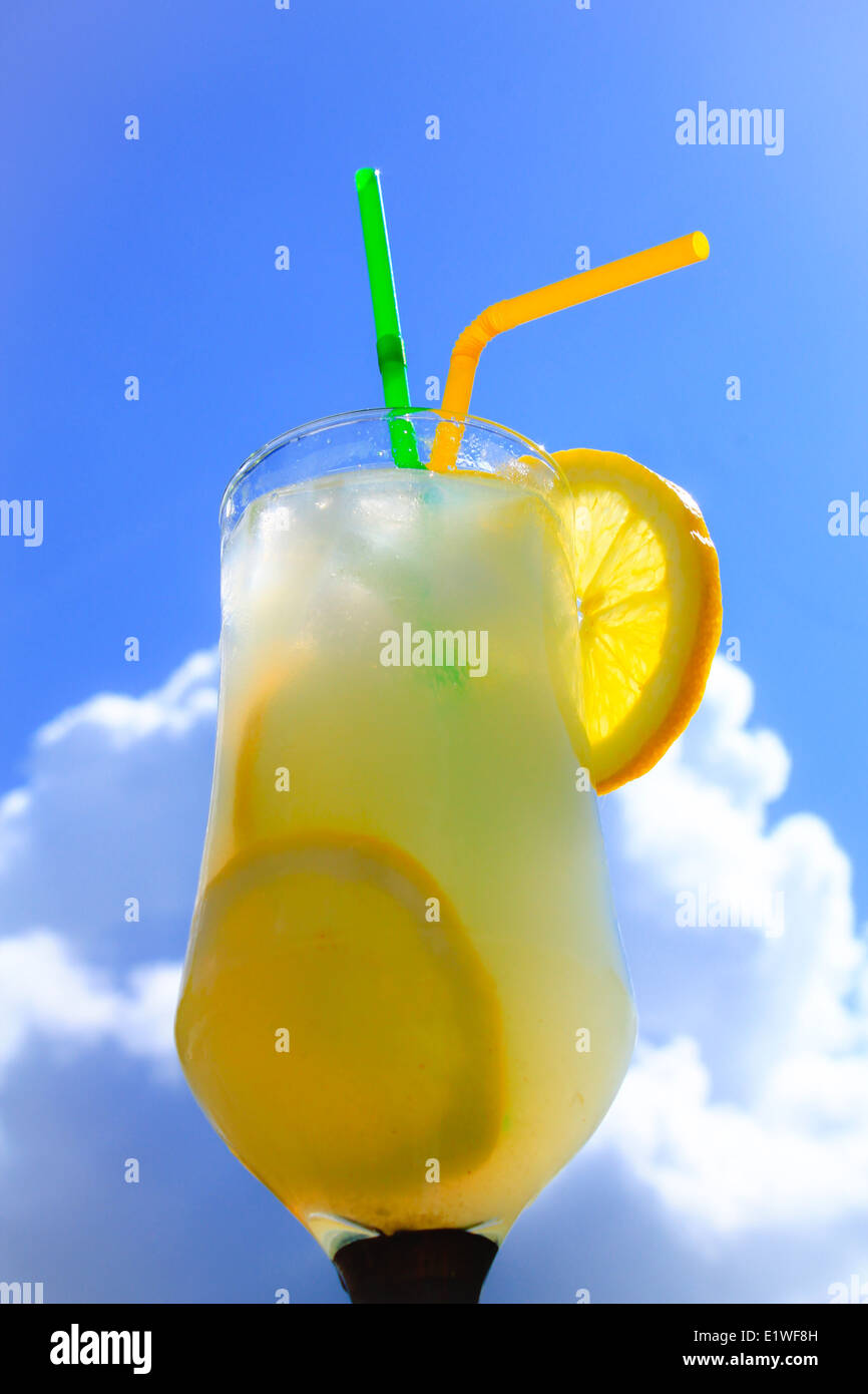 A glass of Lemonade with a blue sky background Stock Photo - Alamy