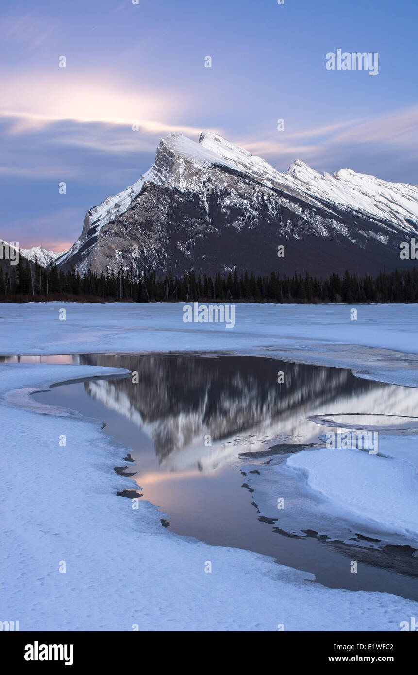 Moon rising behind clouds behind Mount Rundle reflecting in Vermilion ...
