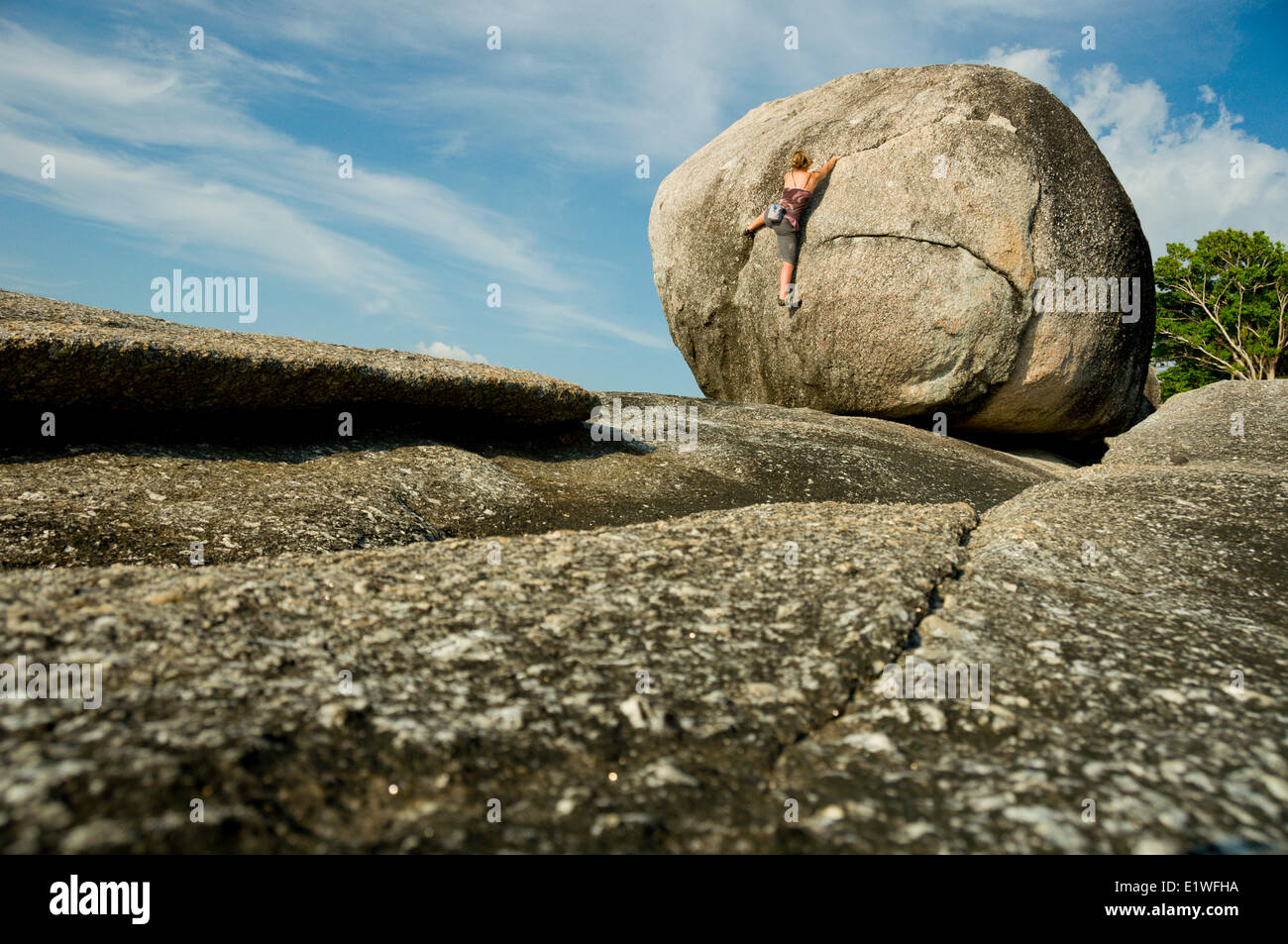 A young woman bouldering near Kata Beach, Phuket, Thailand Stock Photo ...