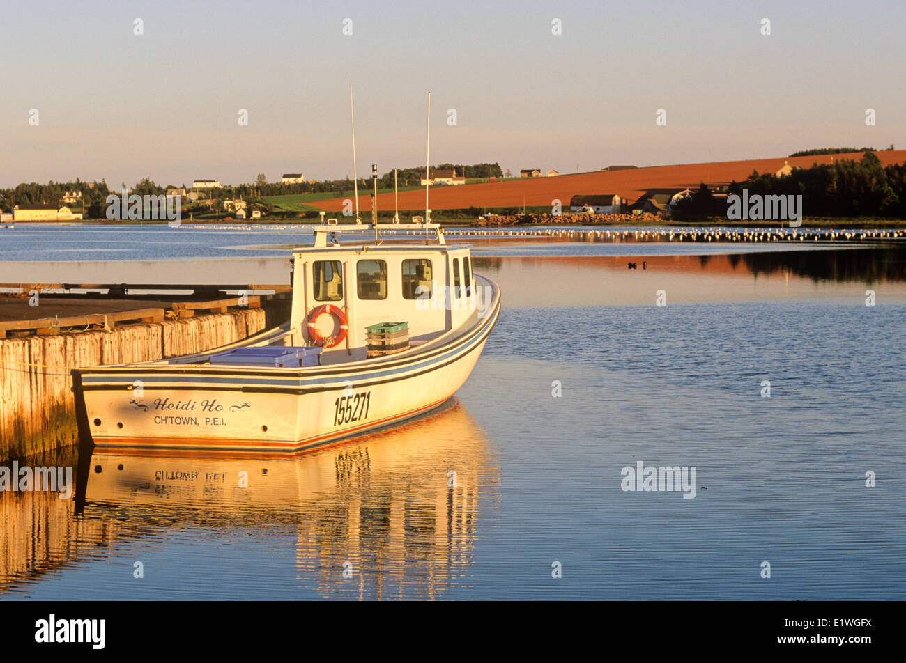 Fishing boats tied up at french river wharf hi-res stock photography ...
