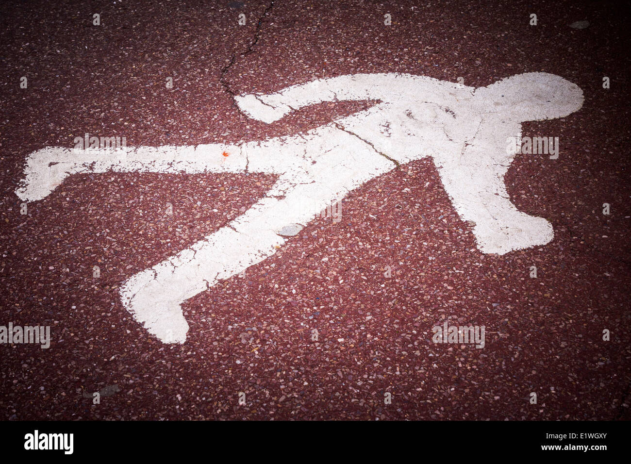 The Pedestrian symbol, painted in white, onto a red asphalt surface ...