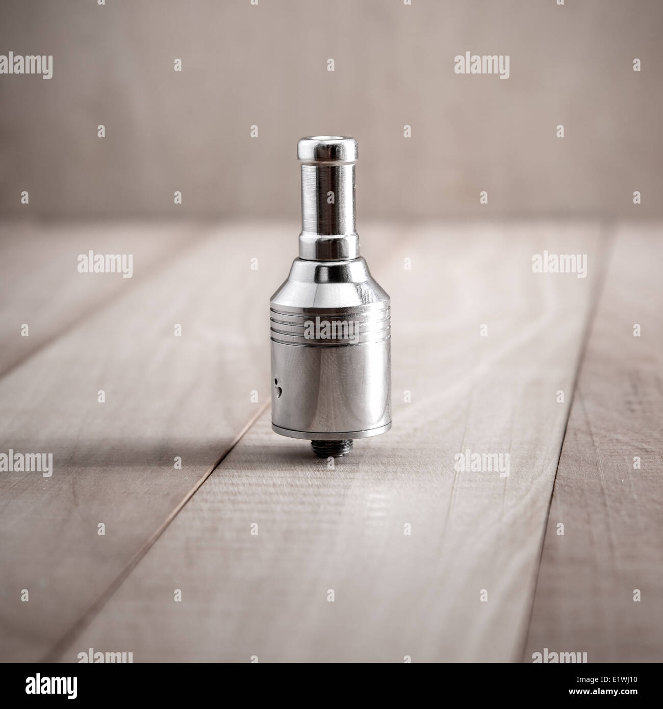Rebuildable Dripping Atomizer on wooden background, shallow depth of ...