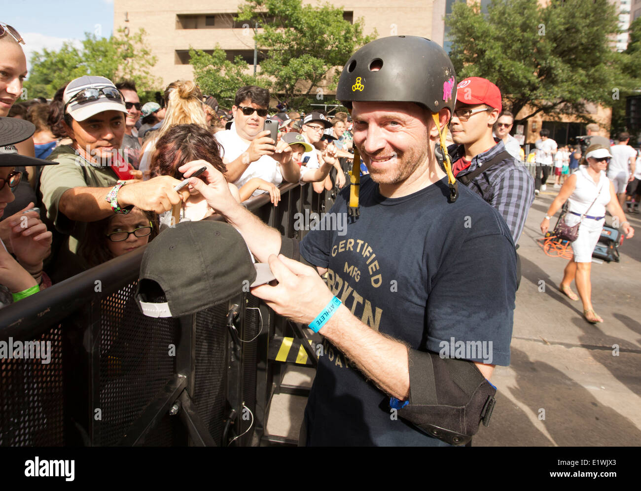 Athlete sign autographs for crowd at X-Games demo held in downtown ...