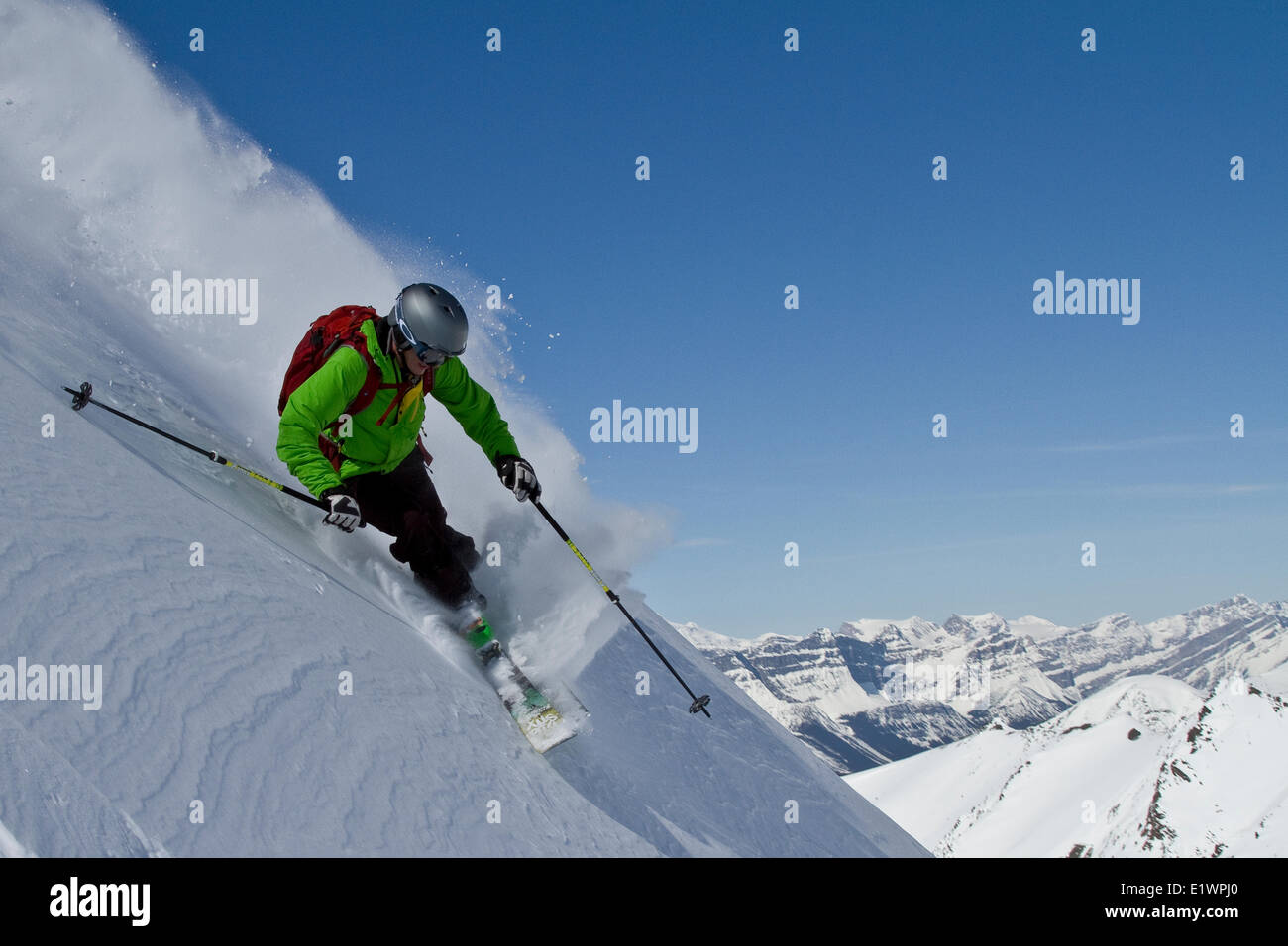 Young male skier skiing untracked slope at Lake Louise Ski Resort ...