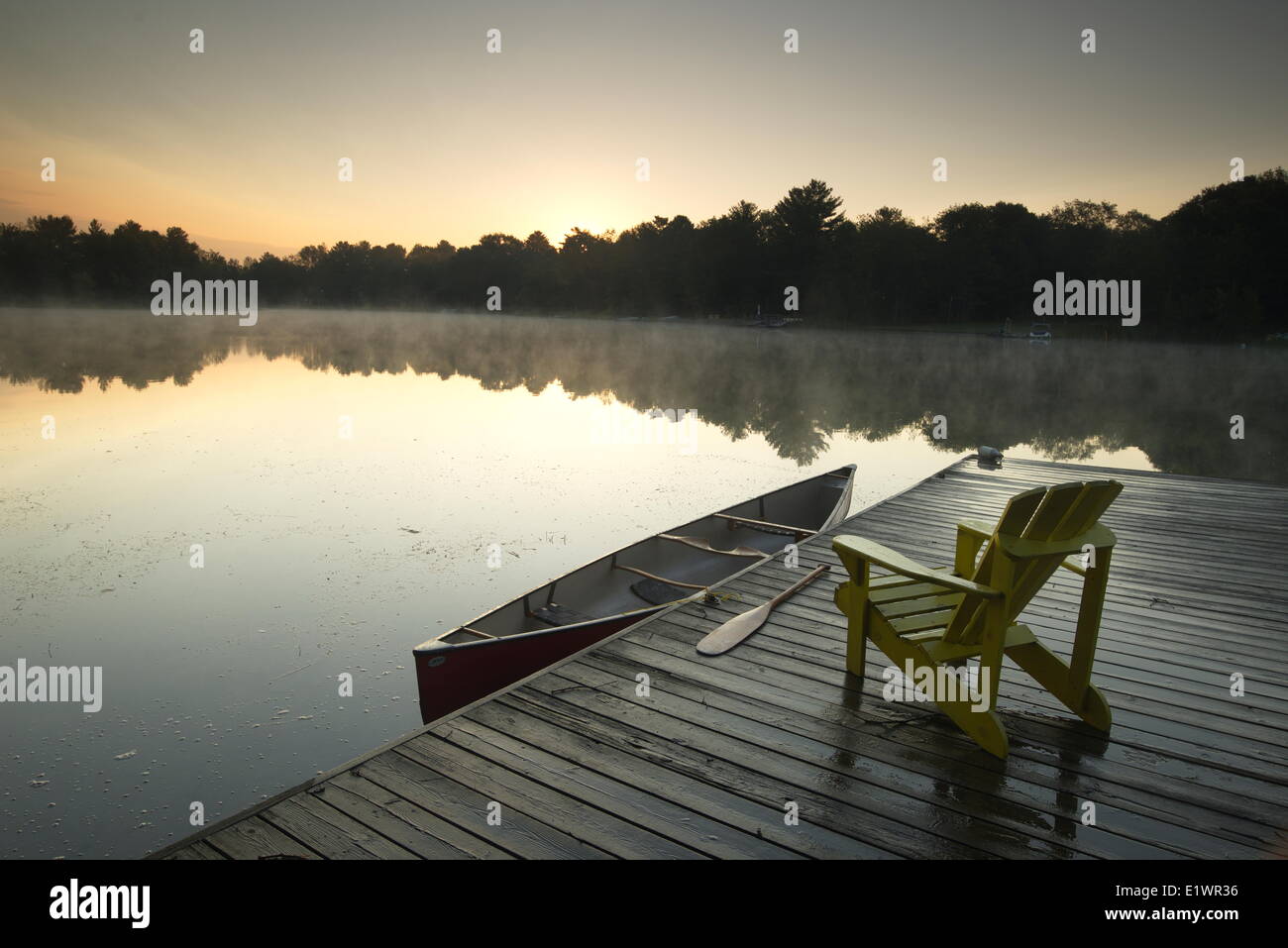 Canoe and Muskoka Chair at the dock in Muskoka, Ontario Stock Photo - Alamy