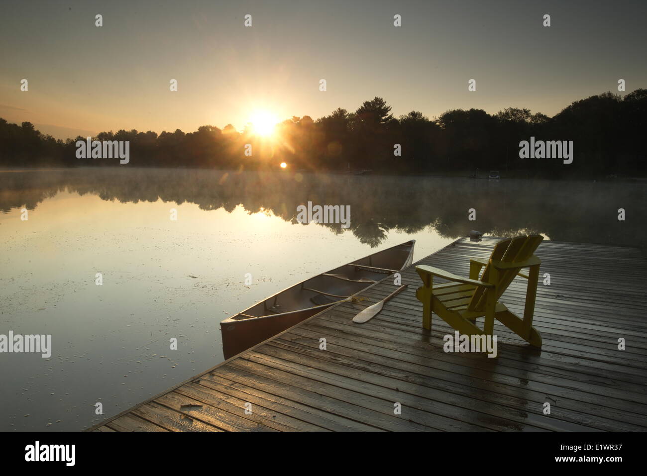 Canoe and Muskoka Chair at the dock in Muskoka, Ontario Stock Photo - Alamy
