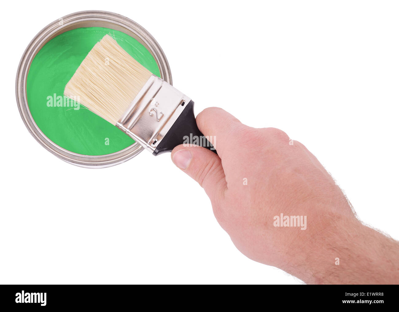 hand about to dip brush into a pot of paint isolated on a white ...