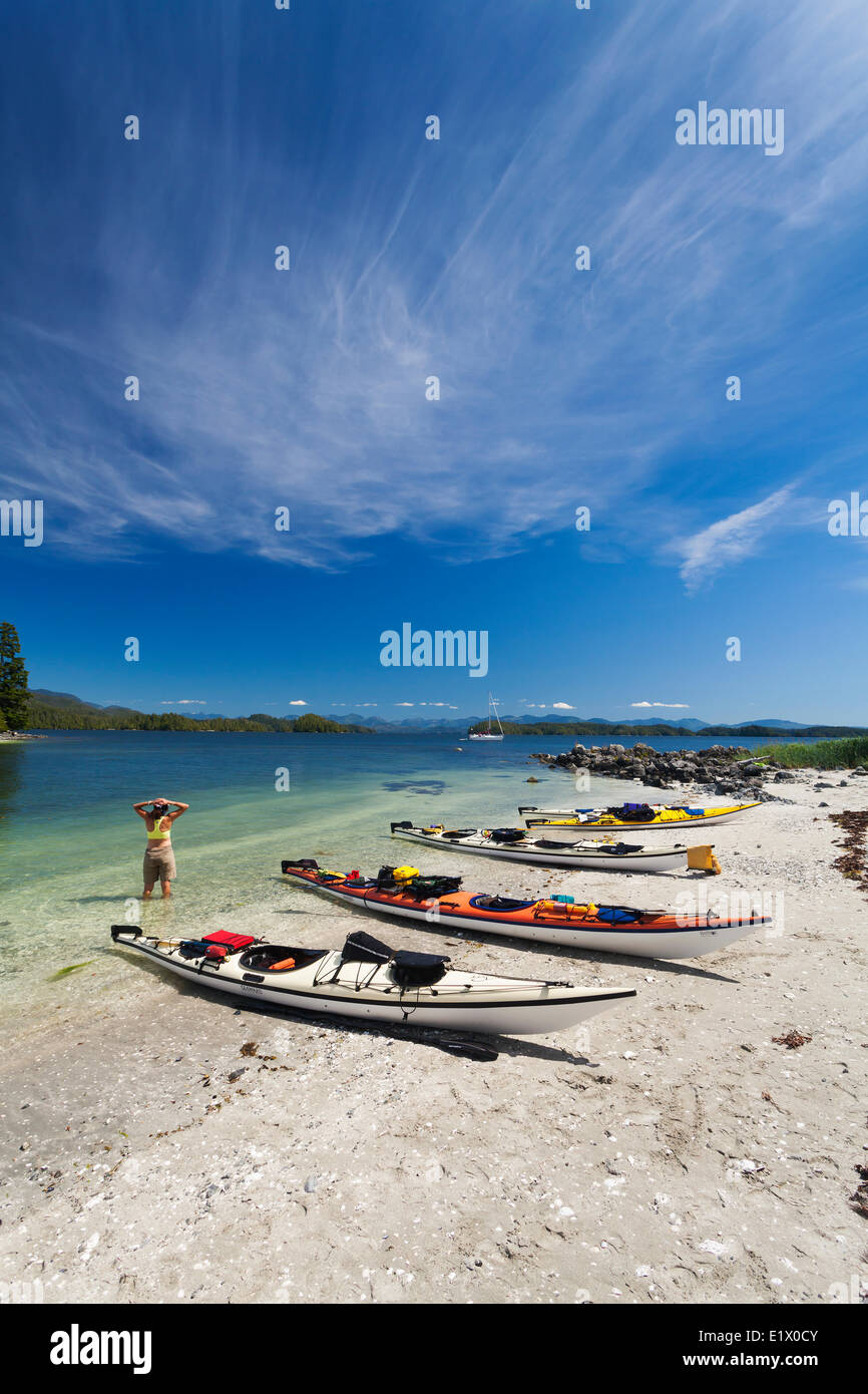 Kayaks line a white sandy beach on Hand Island located within the ...