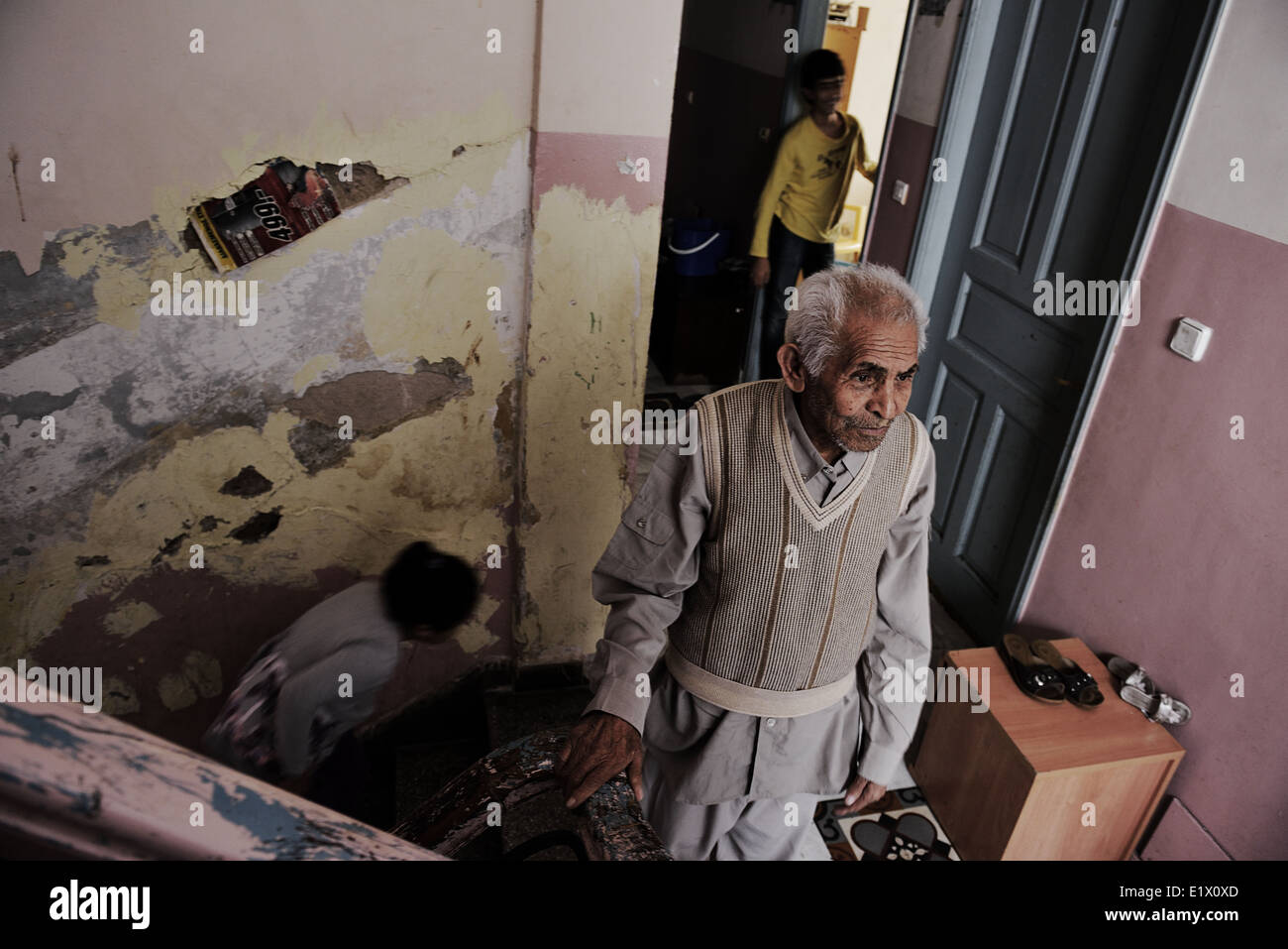 An elderly man from Afghanistan stands out of his apartment, at a ...