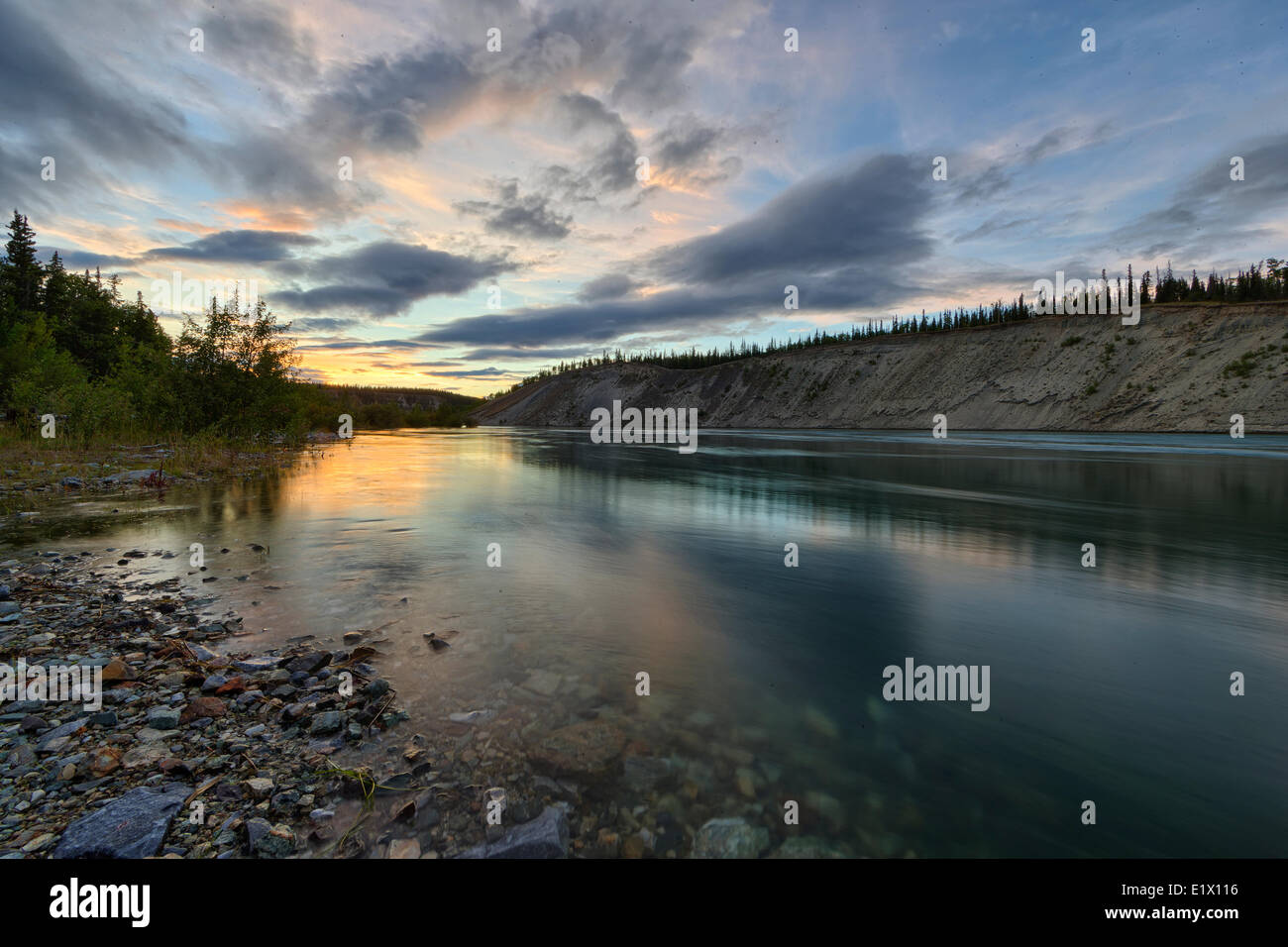 The sky lights up over top of the Yukon River as the sun sets near ...