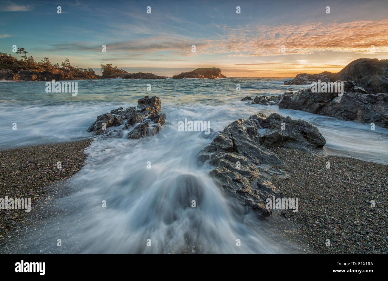 Water flows around the rocks South Beach as high tide sunset approaches ...