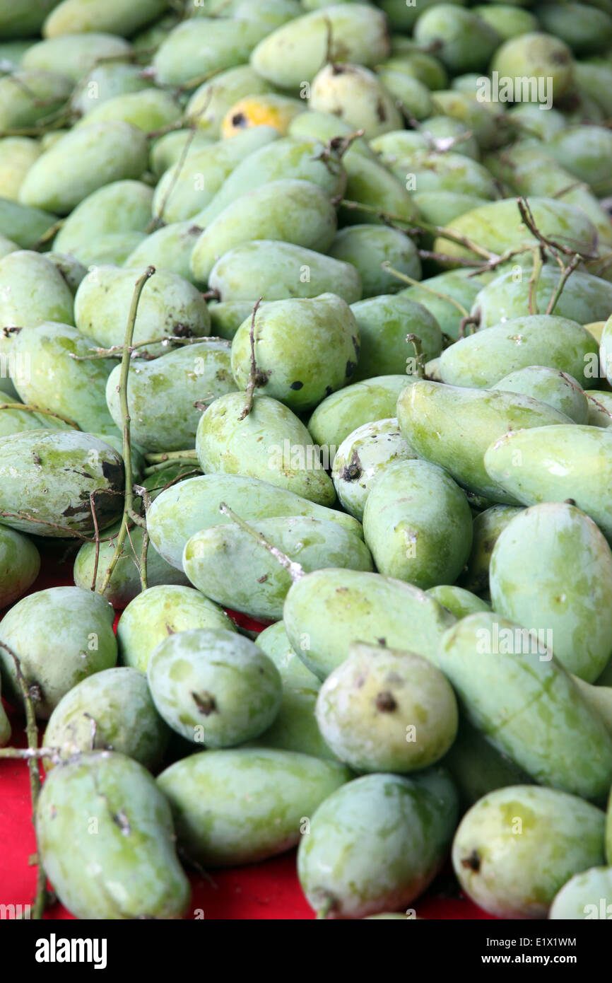 Raw green mangoes in the fruit market for the background Stock Photo ...