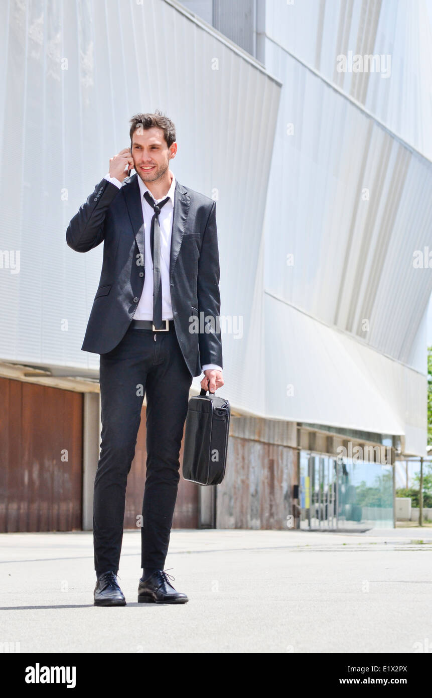 Businessman using cell phone outdoors Stock Photo - Alamy