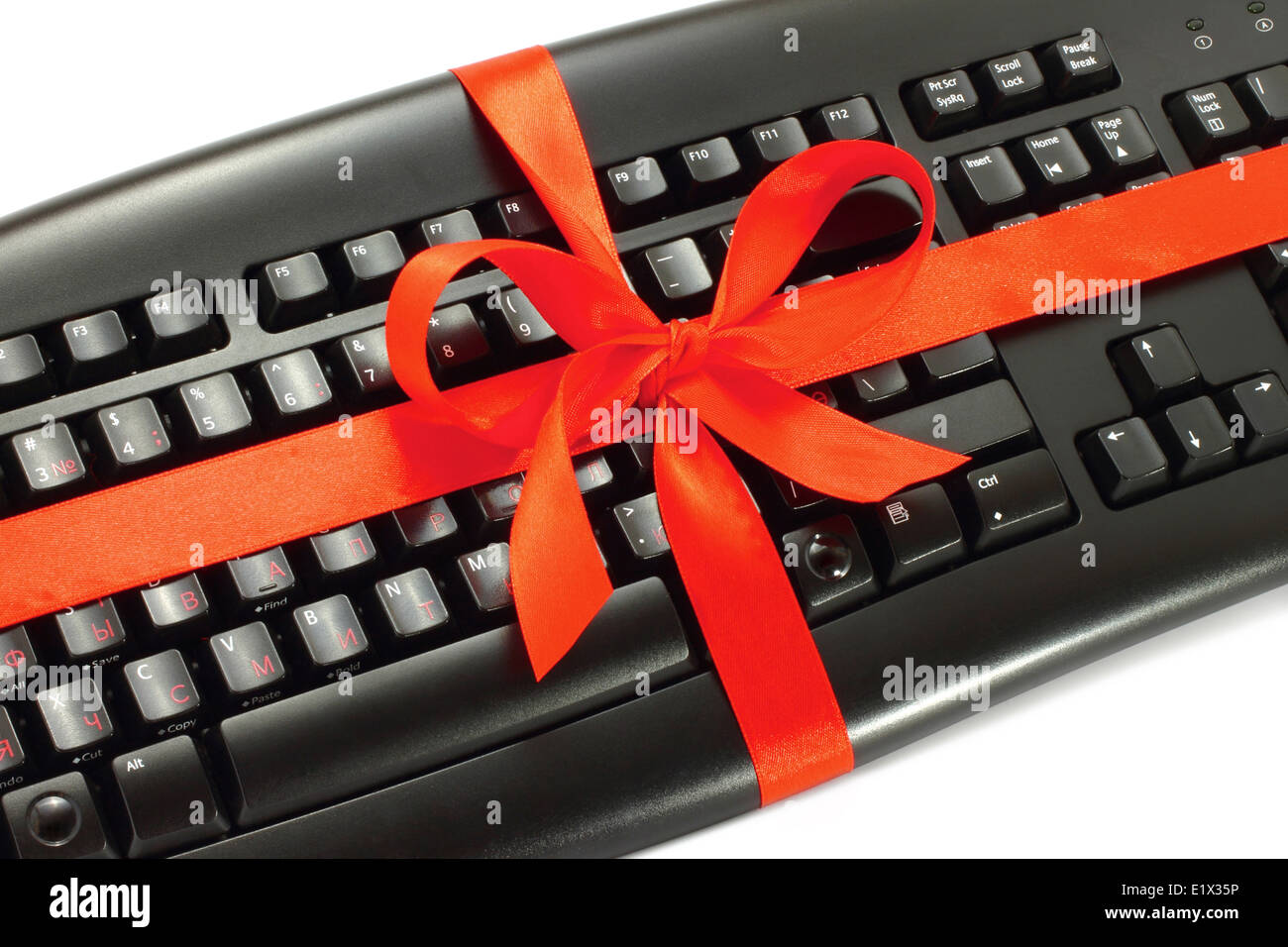 Computer keyboard with red bow on a white background Stock Photo - Alamy
