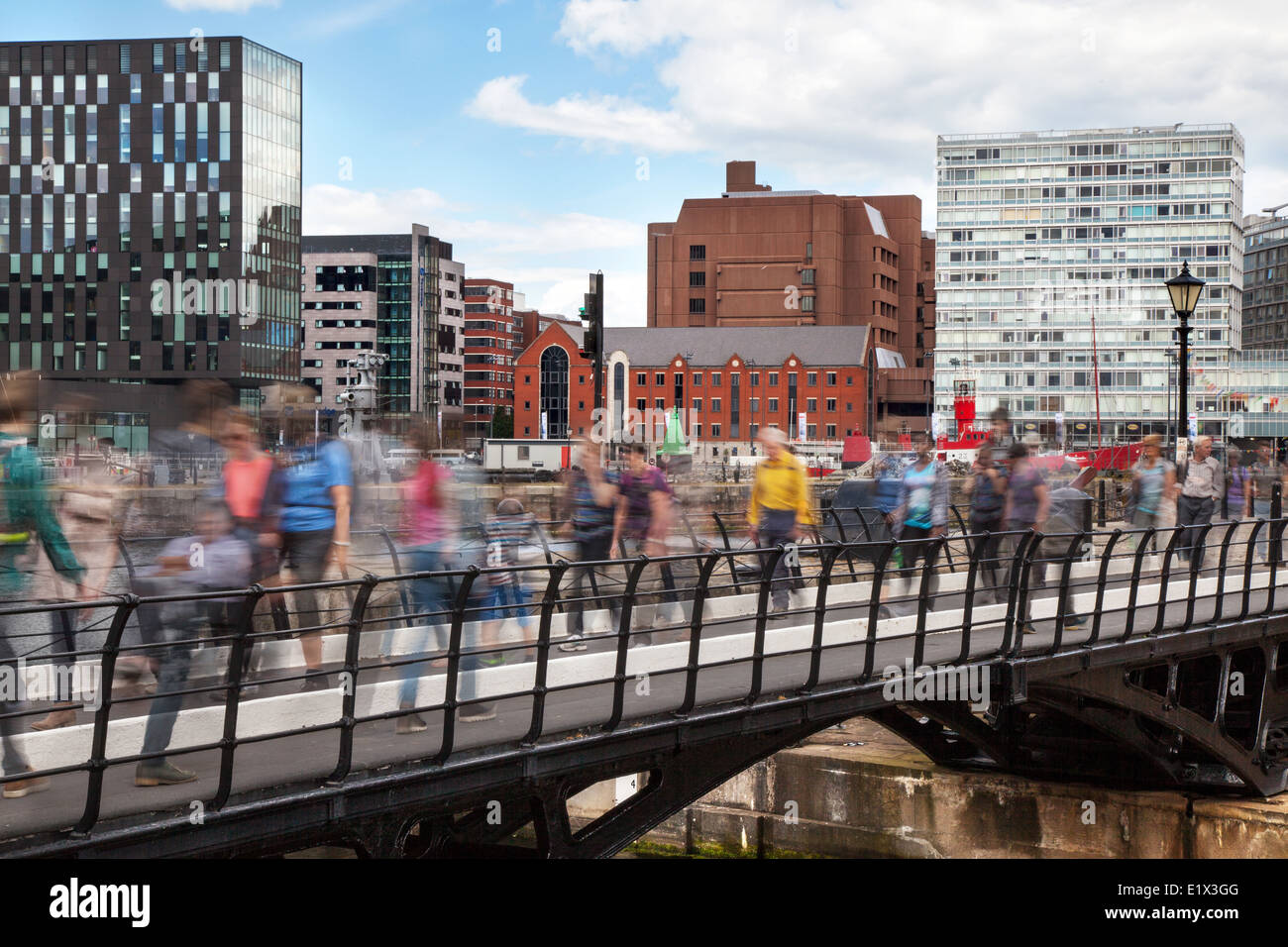 Tourists crossing Hartley swing bridge, Albert Dock, Liverpool ...