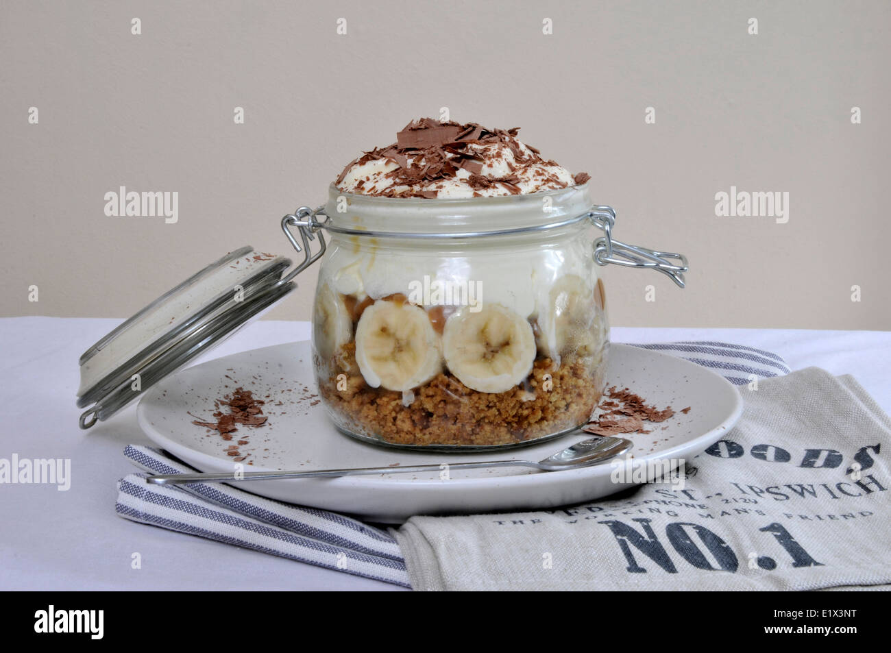 Banoffee pie dessert in a jar sweet cream banana spoon chocolate ...
