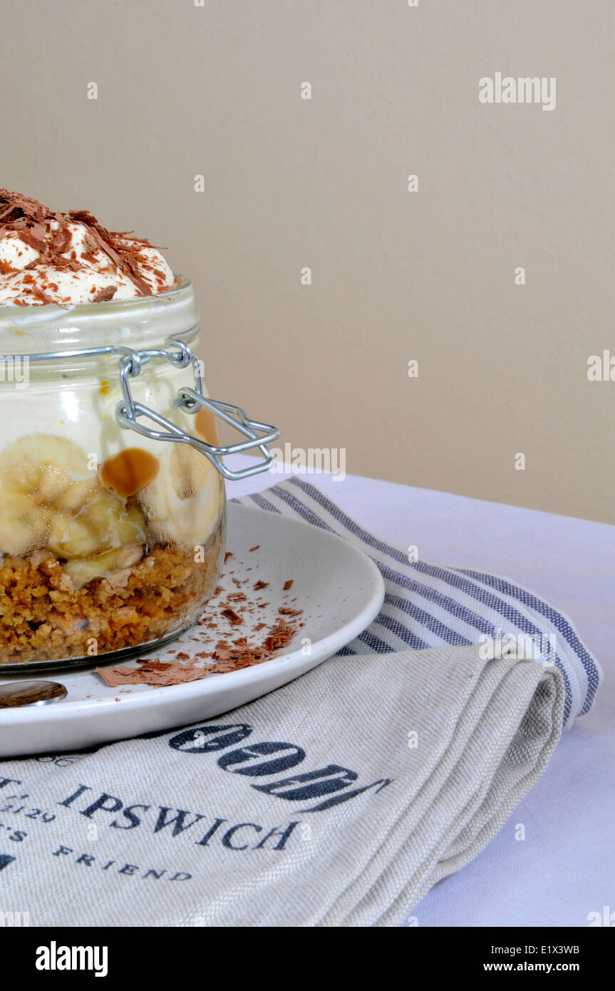 Banoffee pie dessert in a jar sweet cream banana spoon chocolate ...