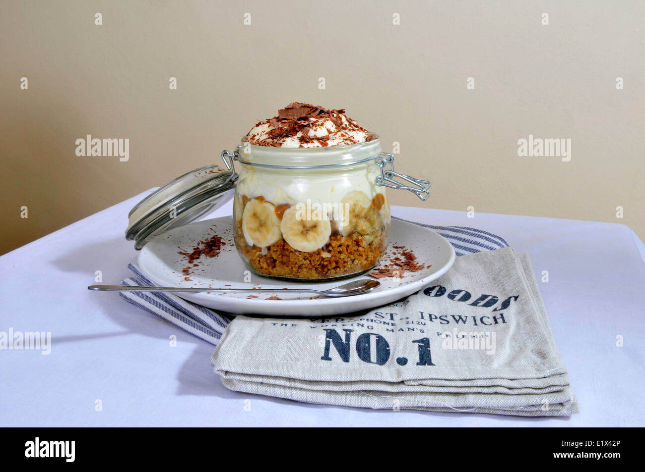Banoffee pie dessert in a jar sweet cream banana spoon chocolate ...