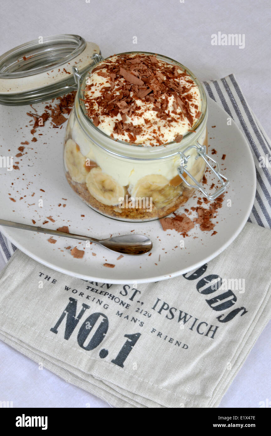Banoffee pie dessert in a jar sweet cream banana spoon chocolate ...