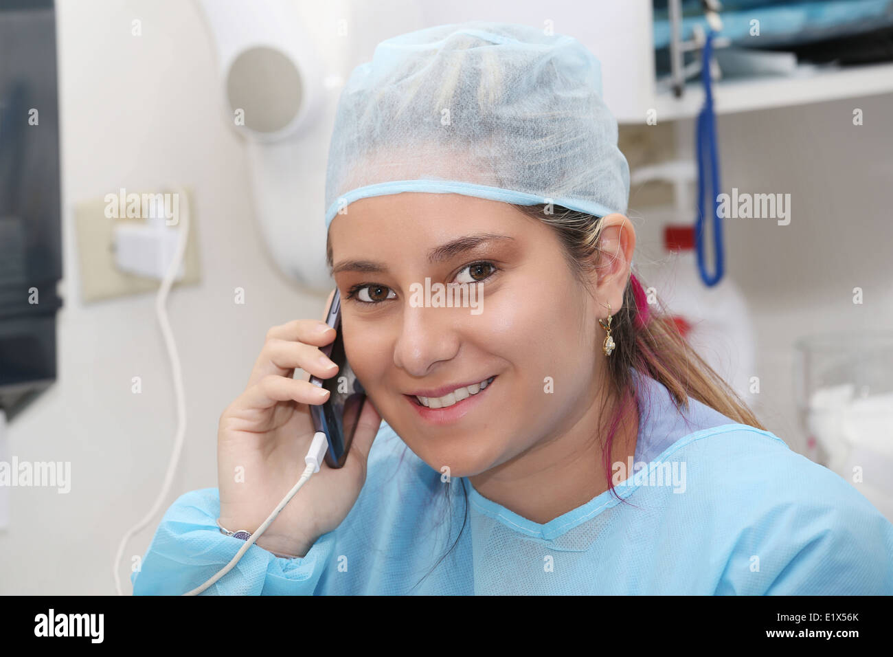 happy female surgeon using mobile phone Stock Photo - Alamy