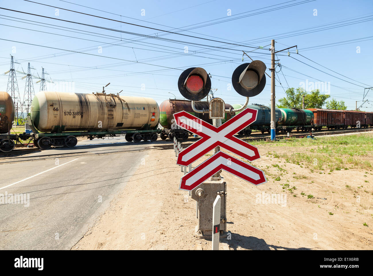 Cargo train riding over a railway crossing Stock Photo - Alamy
