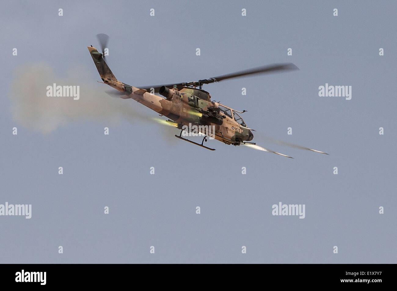 A Jordanian Armed Forces AH-1F Cobra attack helicopter fires rockets ...