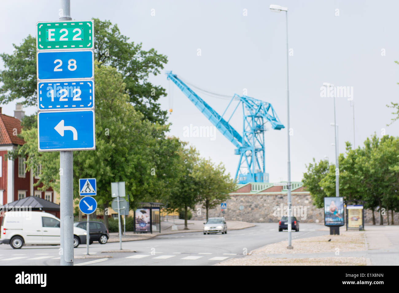 Street in Karlskrona with E22 street sign and dockyard crane in the ...
