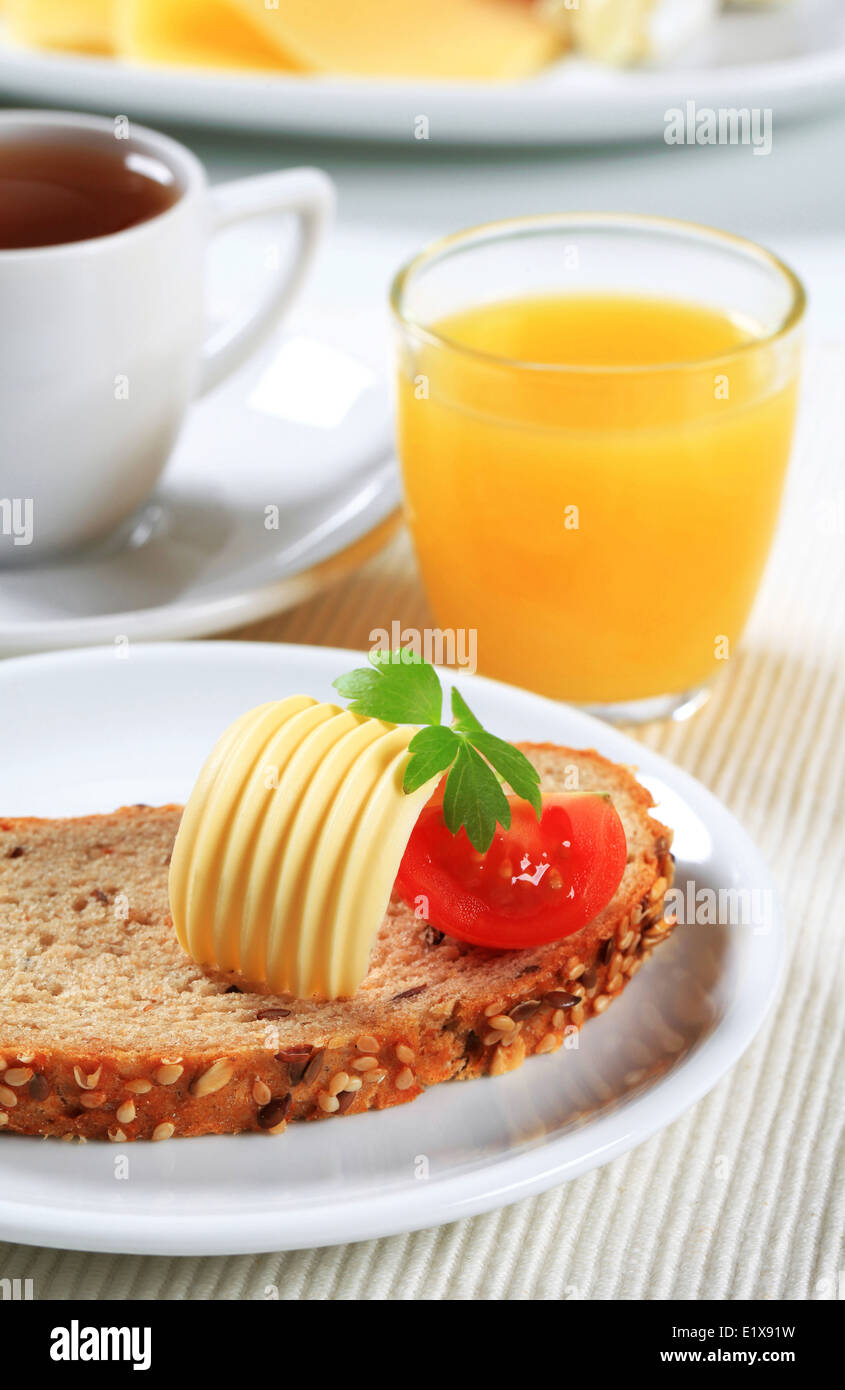 Bread with butter, cup of tea and orange juice - still life Stock Photo ...