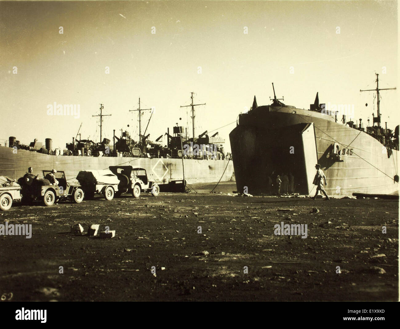 This image captures an LST (Landing Ship Tank) in action during World ...