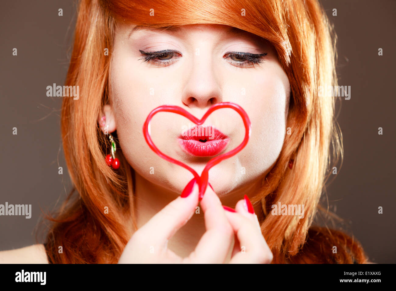Redhaired girl holding red heart love blowing kiss. Valentines day ...
