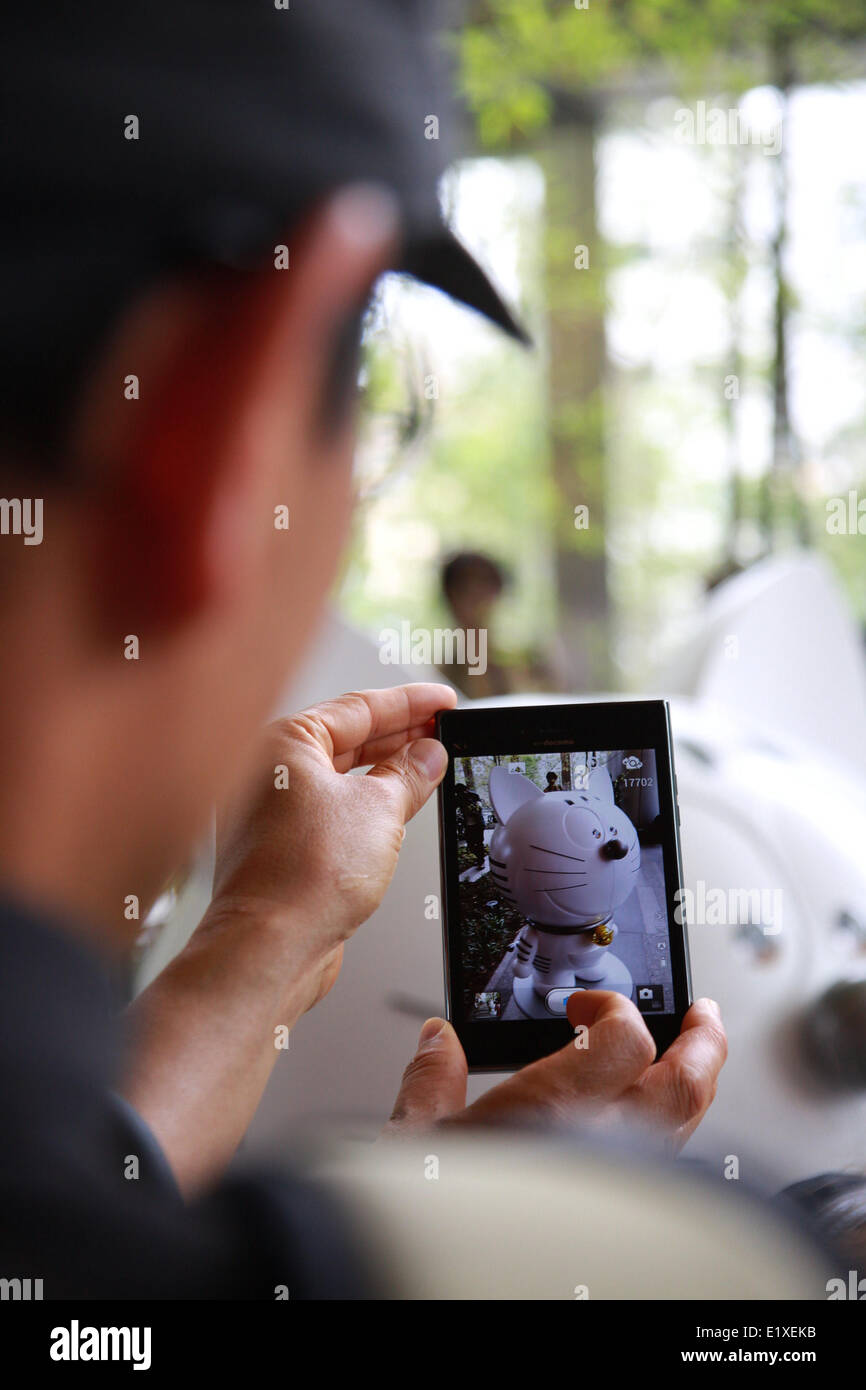Tokyo, Japan. 11th June, 2014. A men takes pictures to the Toranomon ...