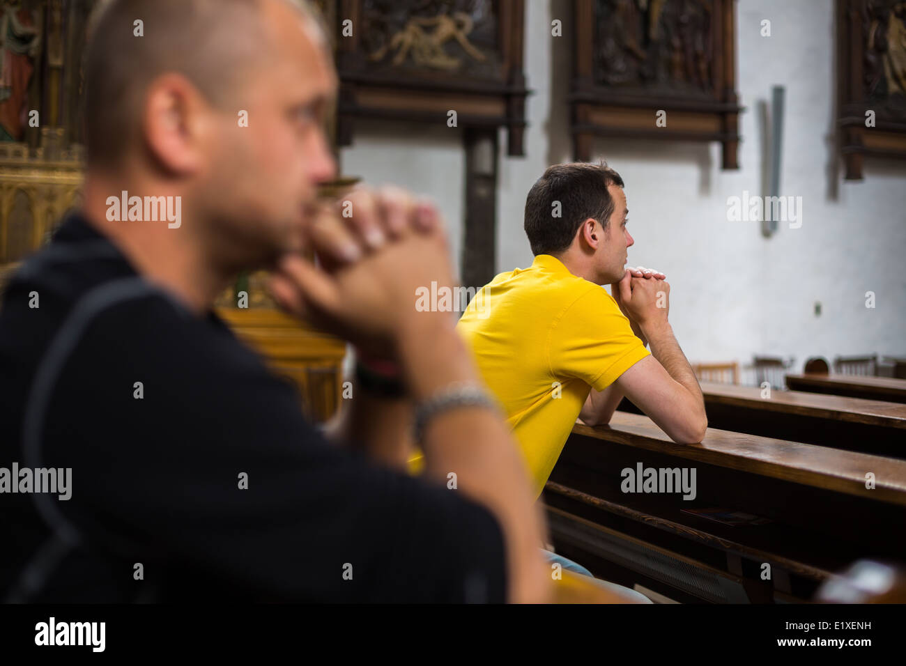 Handsome young man praying in a church Stock Photo - Alamy