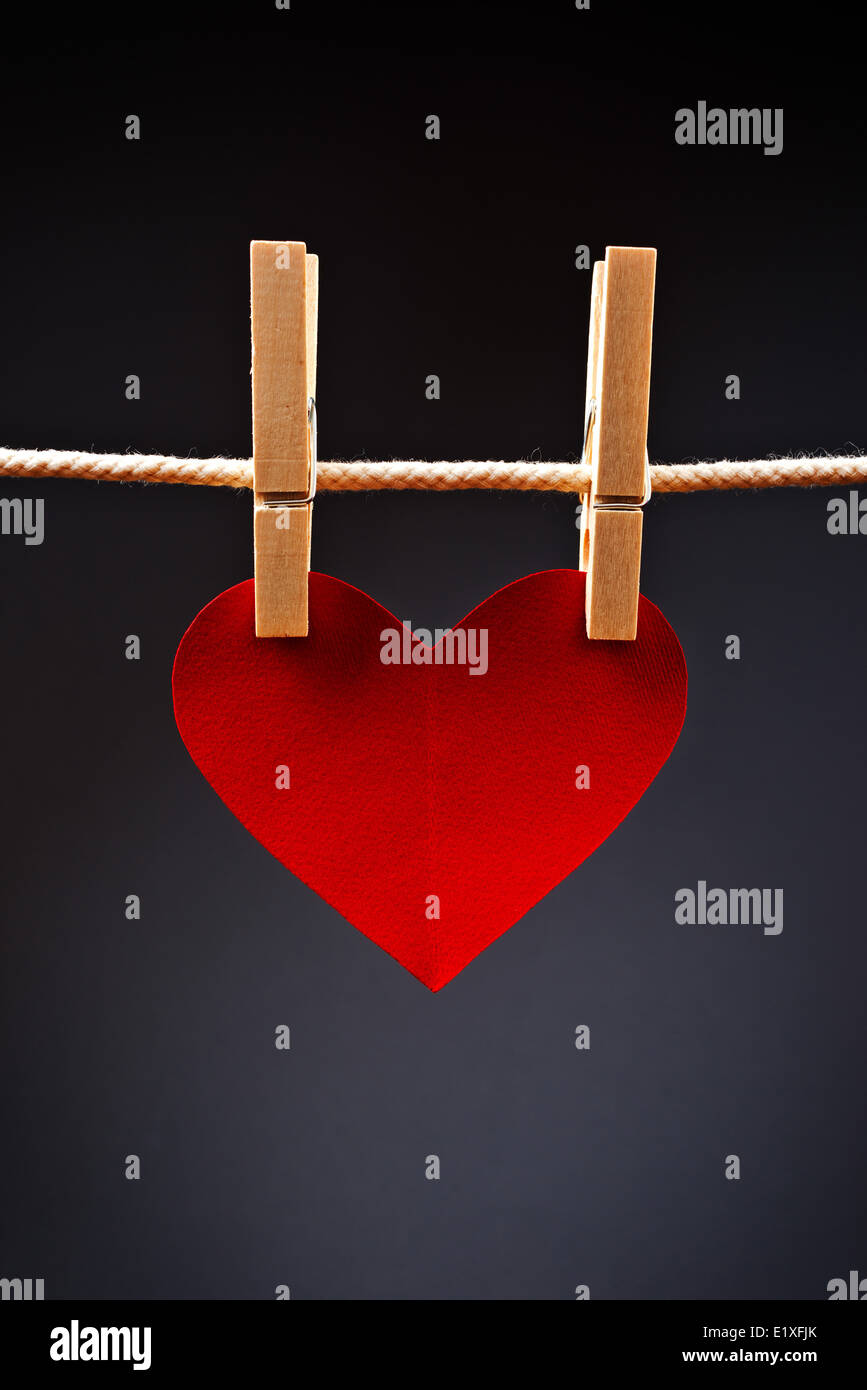 Heart shaped Valentine's Day card with copy space attached to a rope ...