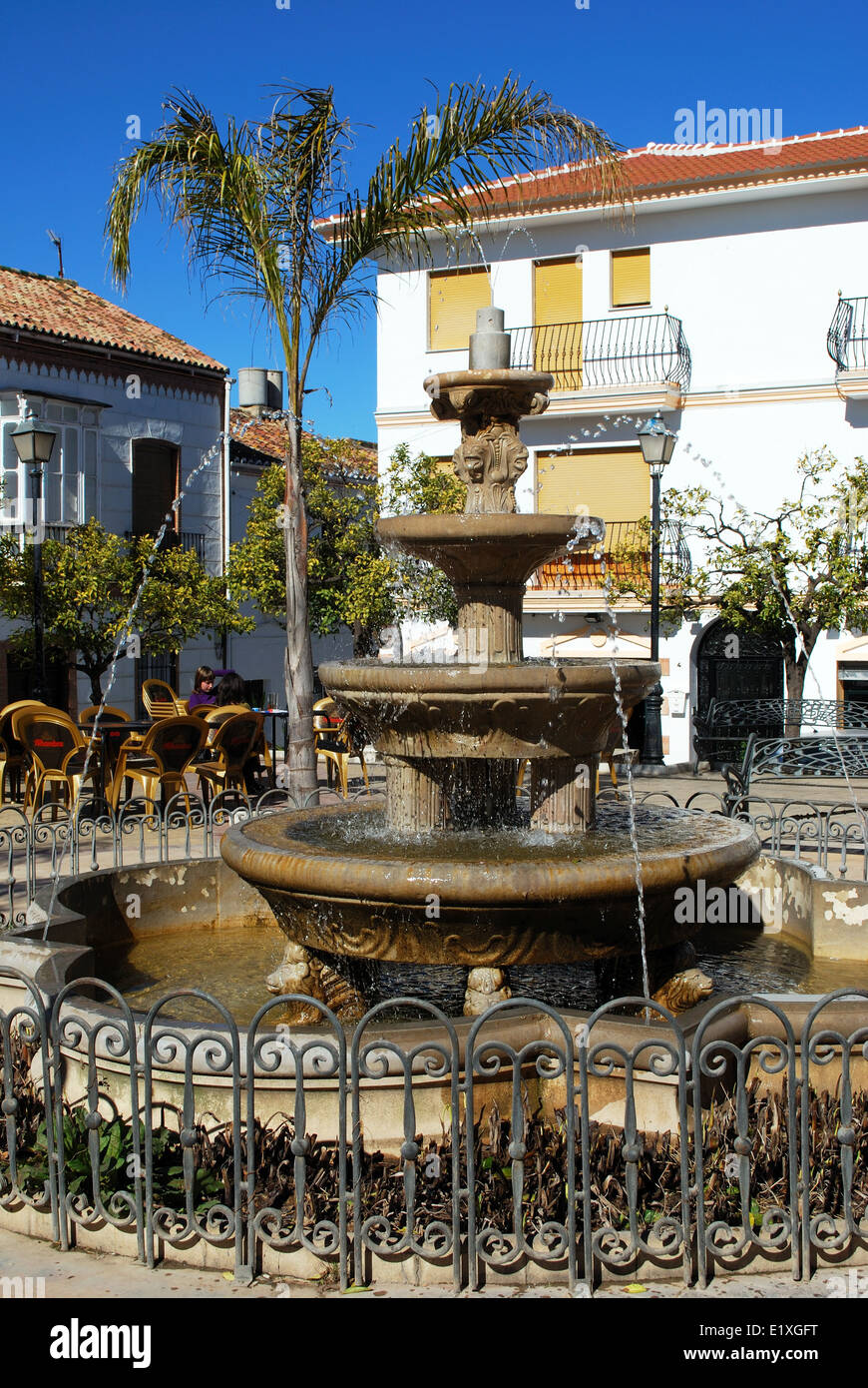 Fountain and pavement cafes in the town square, Colmenar, Andalusia ...