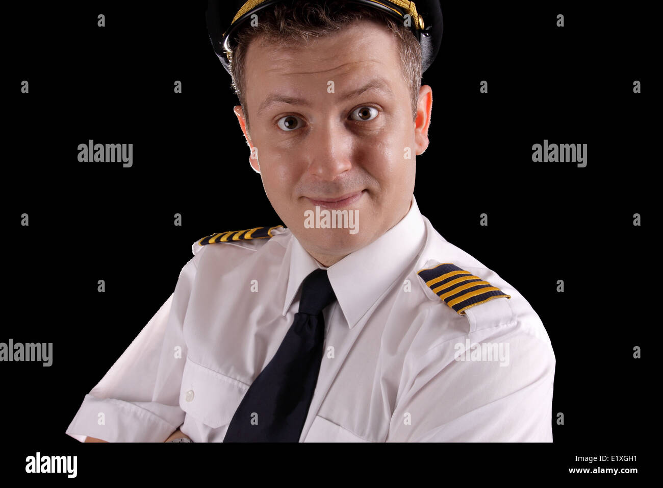 Cheerful captain in uniform on a black background Stock Photo - Alamy