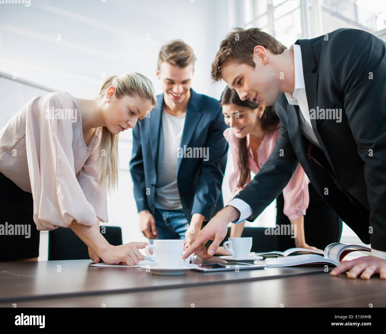 Young business people brainstorming at conference table Stock Photo - Alamy