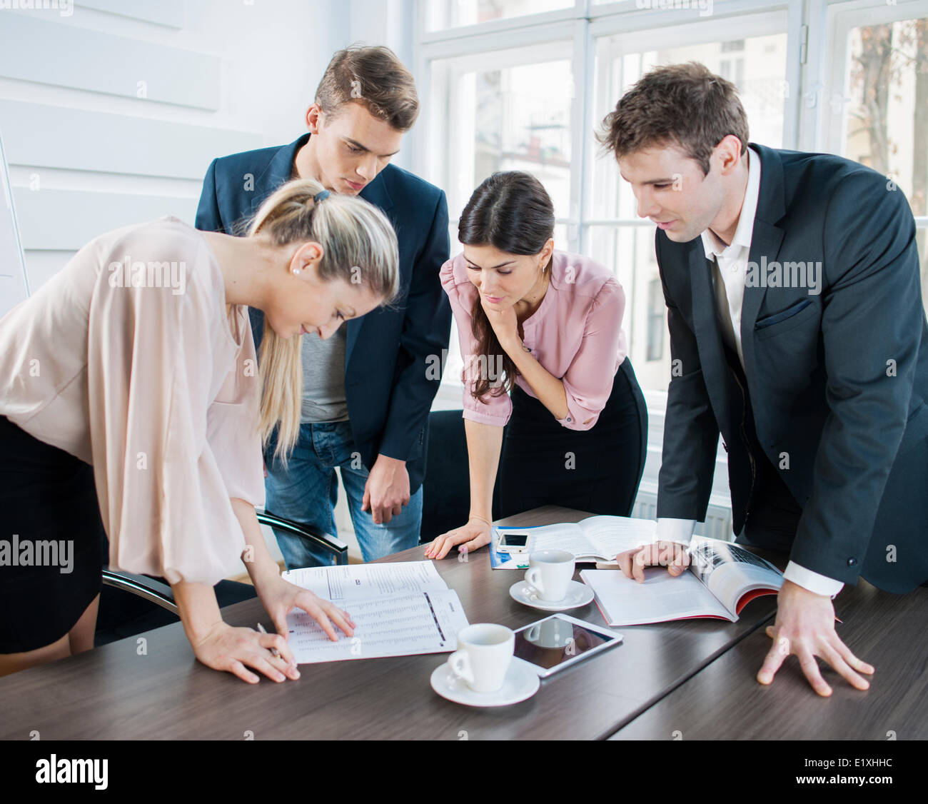 Young business people brainstorming at conference table in office Stock ...