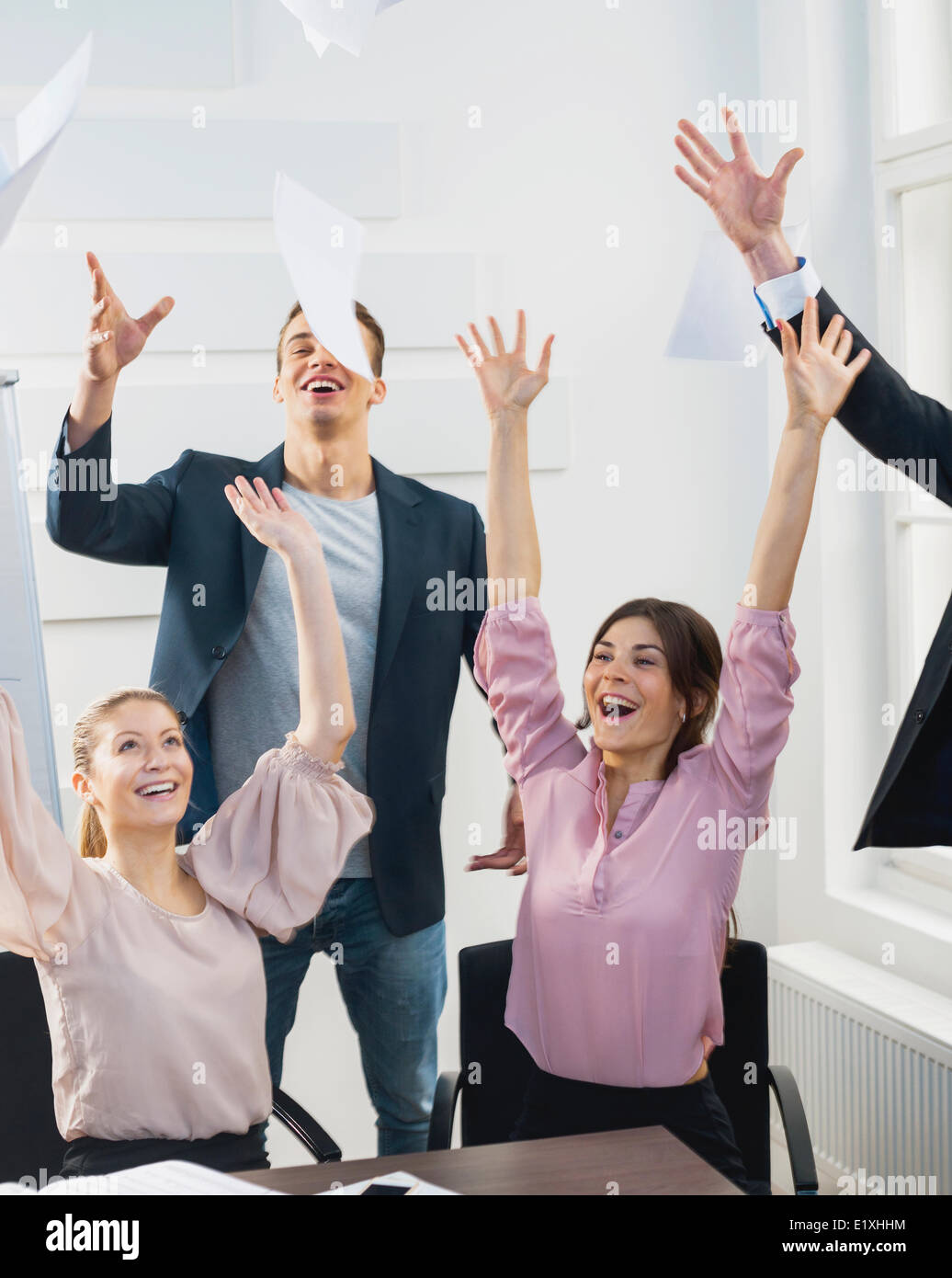 Businesspeople throwing papers in the air at office Stock Photo - Alamy
